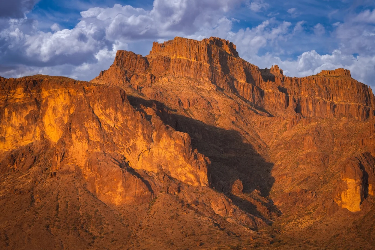 When does the cougar shadow appear on Superstition Mountains?